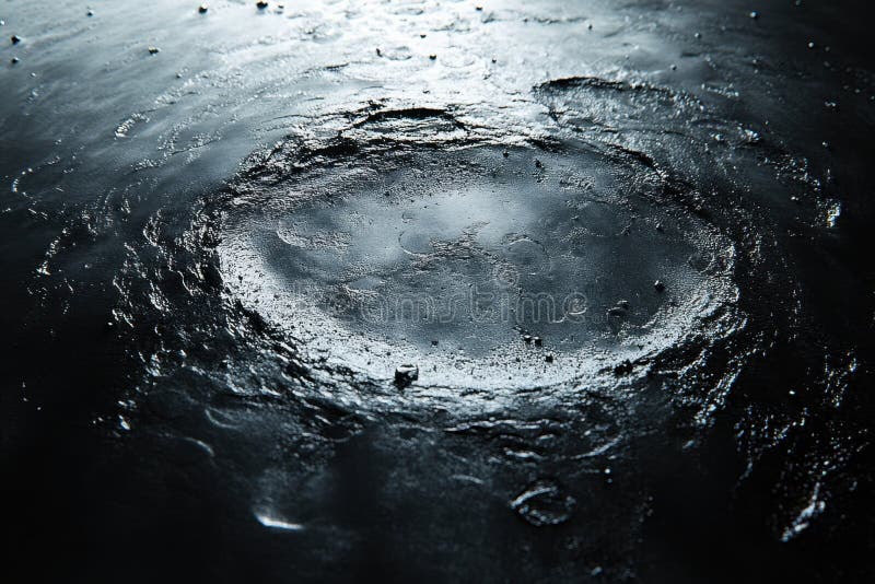 Dark, Reflective Surface Showcasing Texture and Circular Formation ...