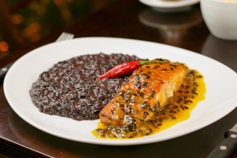 Dark Risotto with Grilled Salmon Stock Photo - Image of purple ...