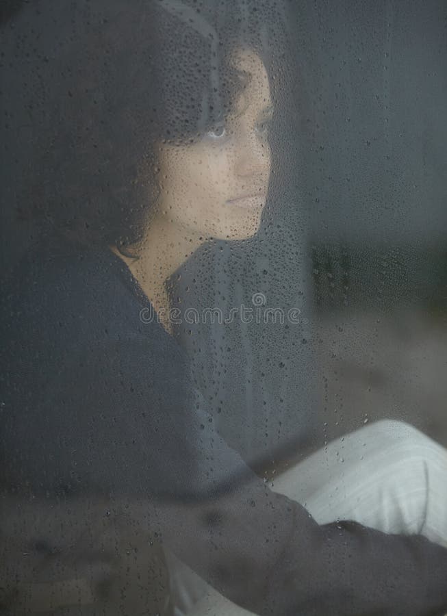 The Dark Side of Depression. a Sad Young Woman Looking Out at the Rain ...