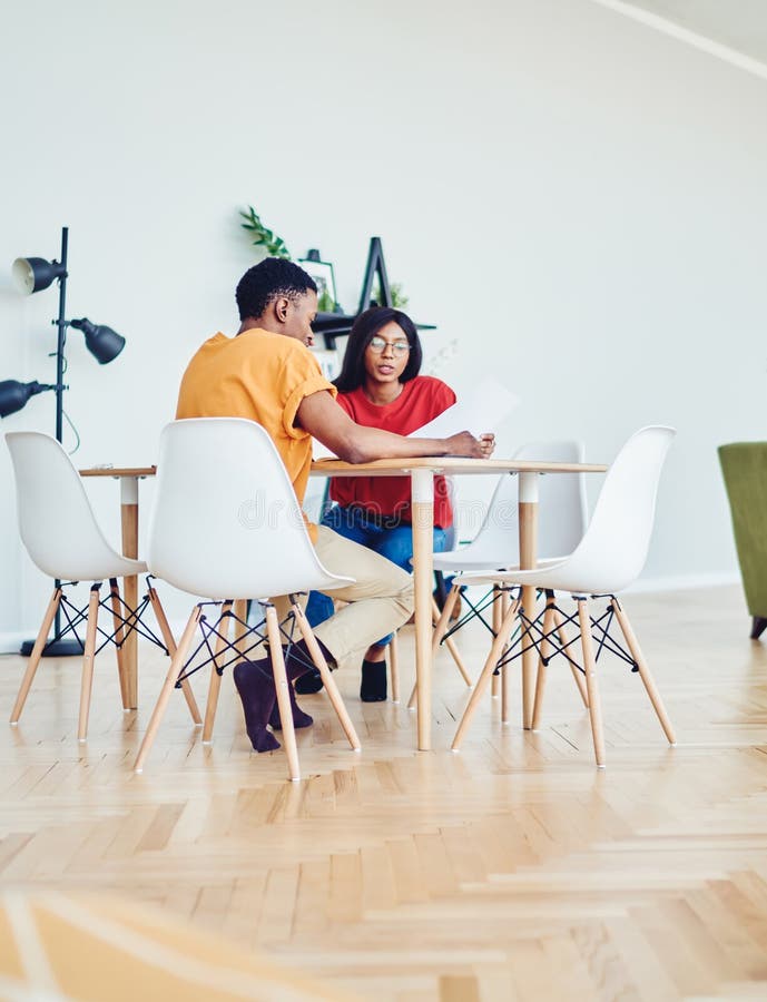 Dark Skinned Colleagues Talking To Each Other Working on Common ...