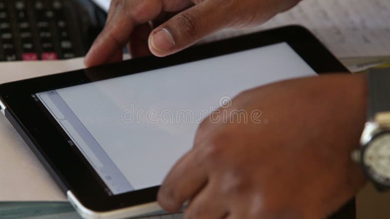 Dark-skinned Man Holding Tablet on Table Waiting for Loading Brouser ...