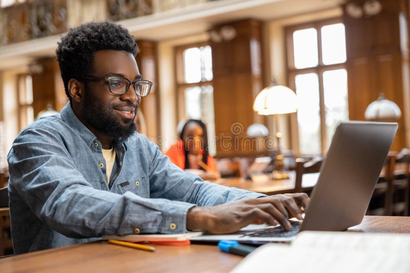 Dark-skinned Young Man Working Online in the Library Stock Image ...