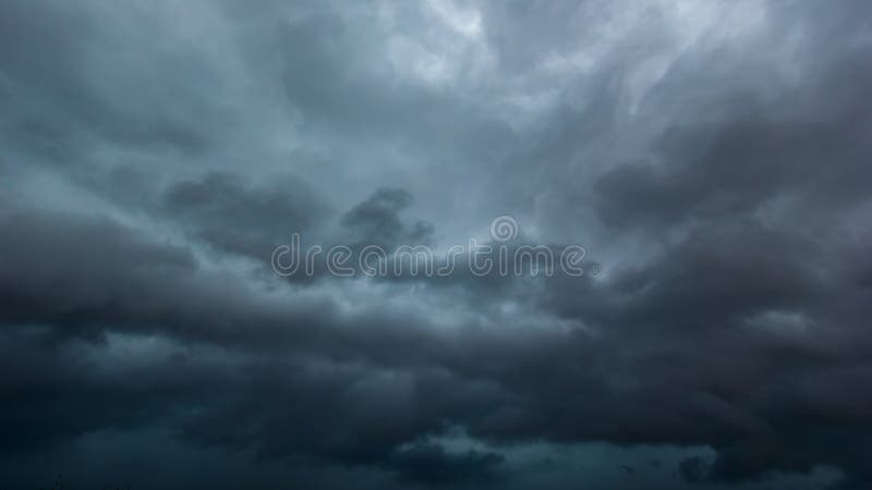 The Dark Sky with Heavy Clouds Converging and a Violent Storm before ...