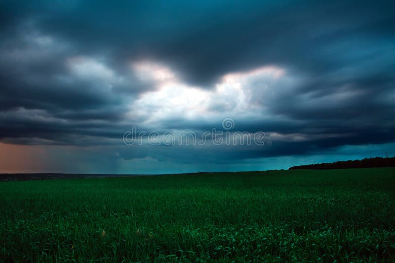 Dark Sky with Rain Clouds Over Green Field Stock Image - Image of ...