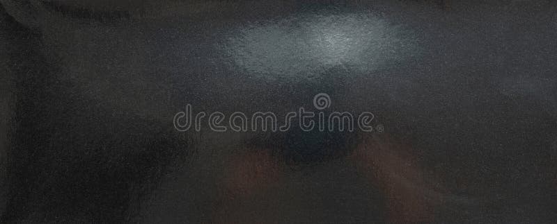 Smooth Black Surface with Reflections and Subtle Textures in Dimly Lit ...