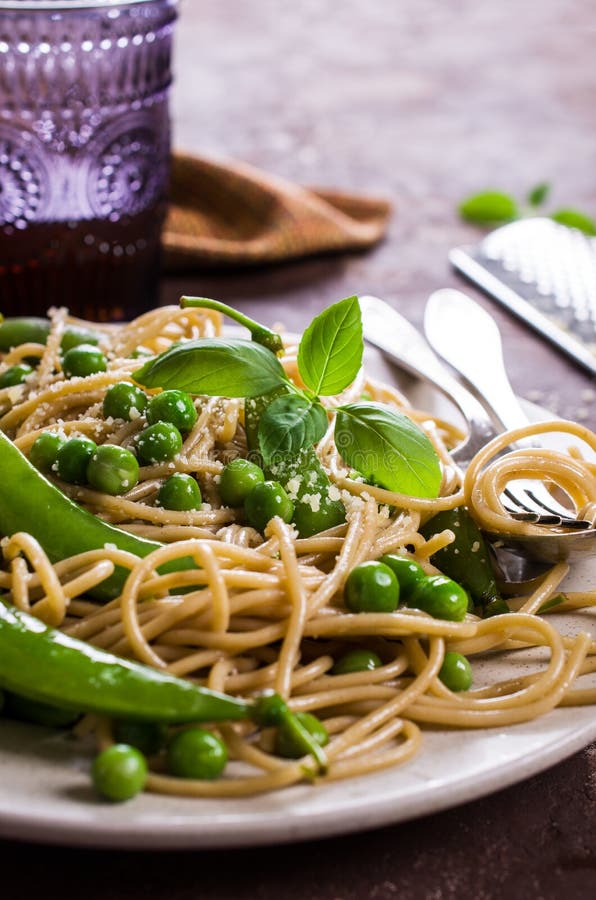 Dark spaghetti with peas stock photo. Image of leaf, dark - 93228370