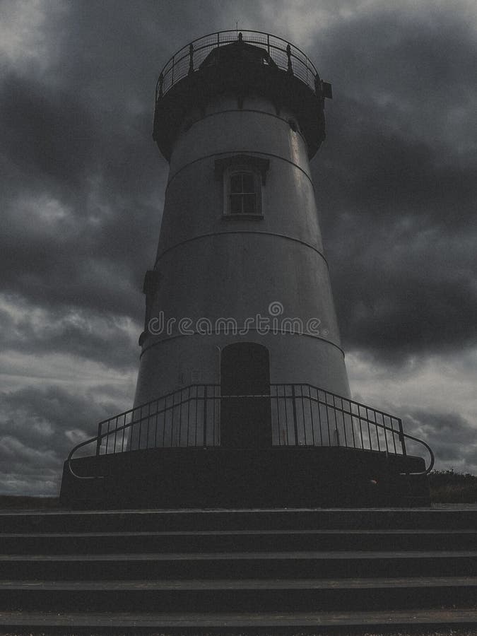 Dark, spooky lighthouse stock image. Image of white - 335311783
