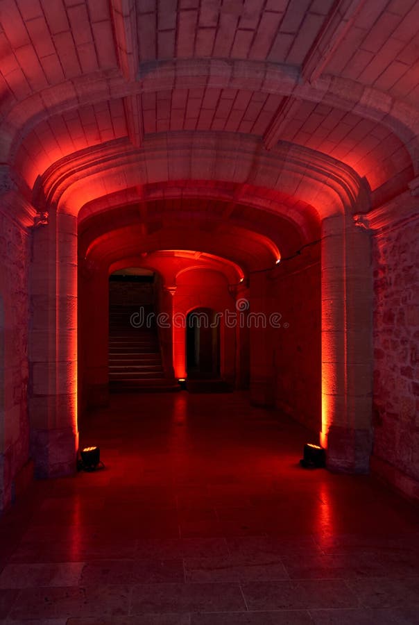 Dark Stone Interior Hallway Illuminated with Red Lights and at the End ...