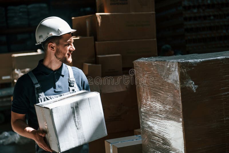In Dark Store. Employee in Uniform is Working in the Storage Stock ...