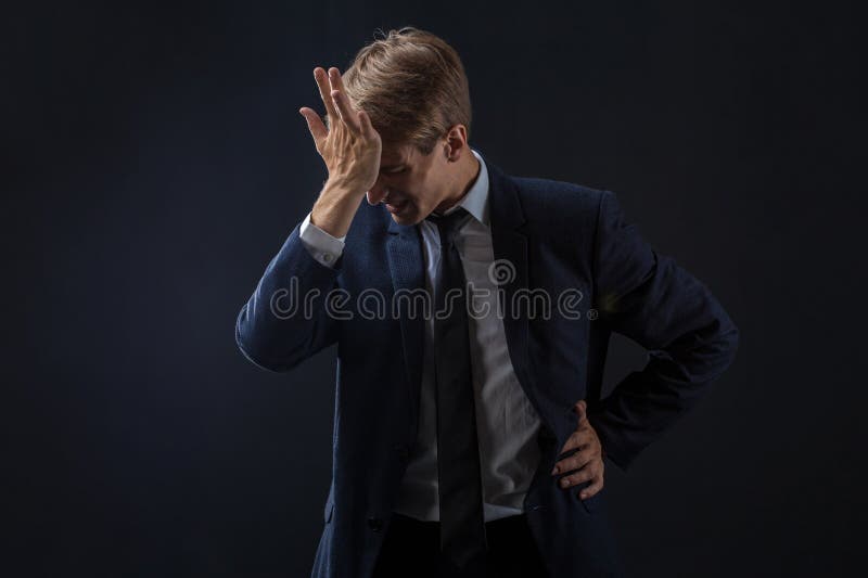 In a Dark Studio Setting, a Man in a Suit Gestures Animatedly with Both ...