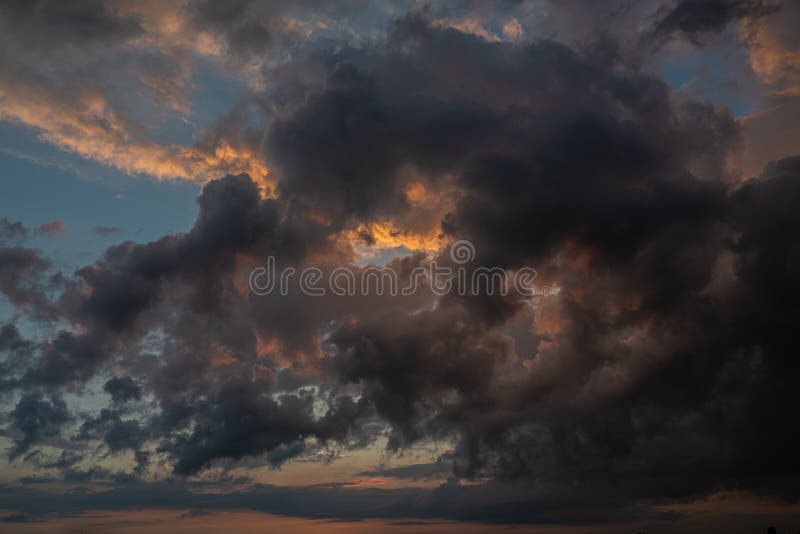 A Dark Thundercloud on the Background of Sunset Stock Photo - Image of ...