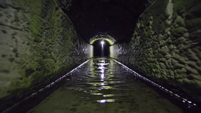 Dark Underground Tunnel with Water Reflection and Single Light Source ...