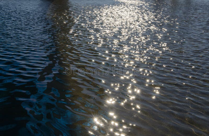 Dark Water with Sun Reflections Stock Photo - Image of reflection ...
