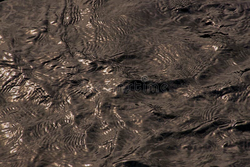 Dark Wavy Water with Bright Reflection of Sunlight. Stock Photo - Image ...
