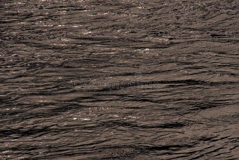 Dark Wavy Water with Bright Reflection of Sunlight. Stock Image - Image ...