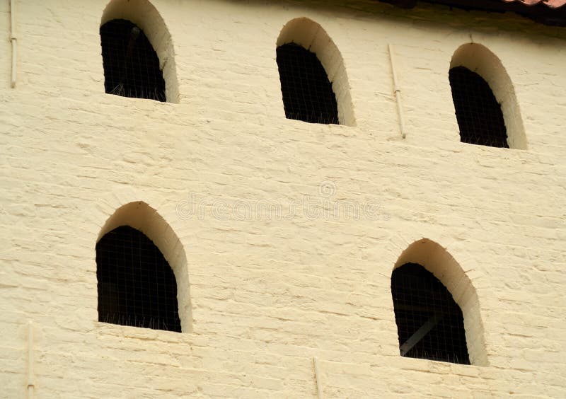 Dark Window Openings on the Light Whitewashed Side of a Historic Church ...