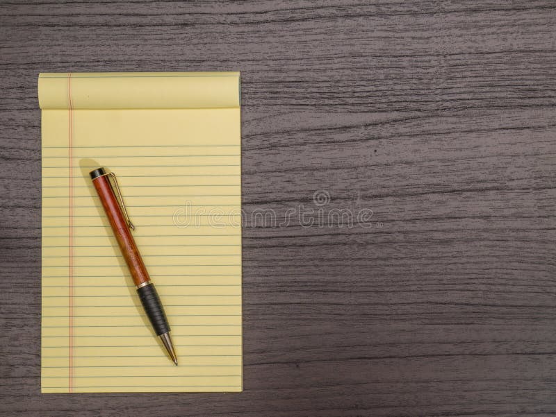Dark Wood Desk, Yellow Pad, Pen on Pad Stock Photo - Image of dark ...