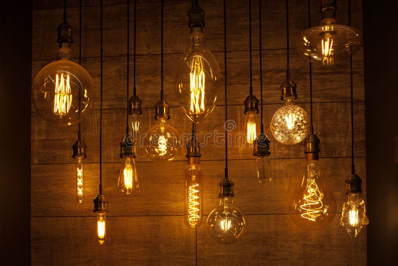 On a Dark Wooden Background Hang Burning Light Bulbs of Different ...
