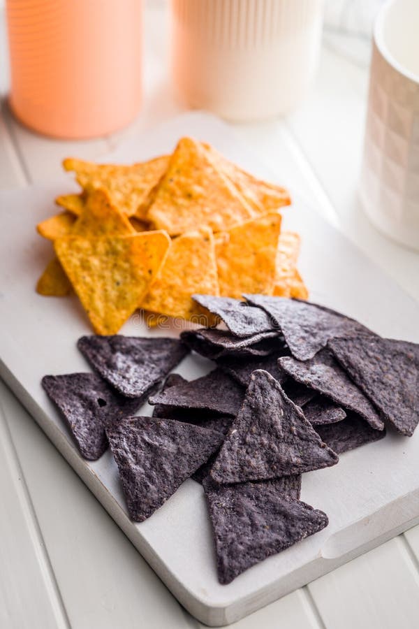 Dark and Yellow Nachos Chips on White Table Stock Image - Image of ...