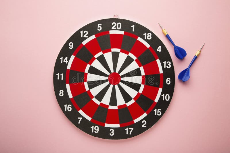 Dart Board with Blue and Red Darts on Green Background Stock Photo ...