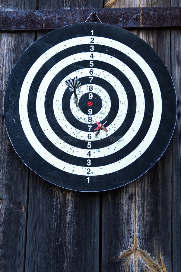 Dartboard Against Old Tree Background. Two Darts Hit the Target of a ...