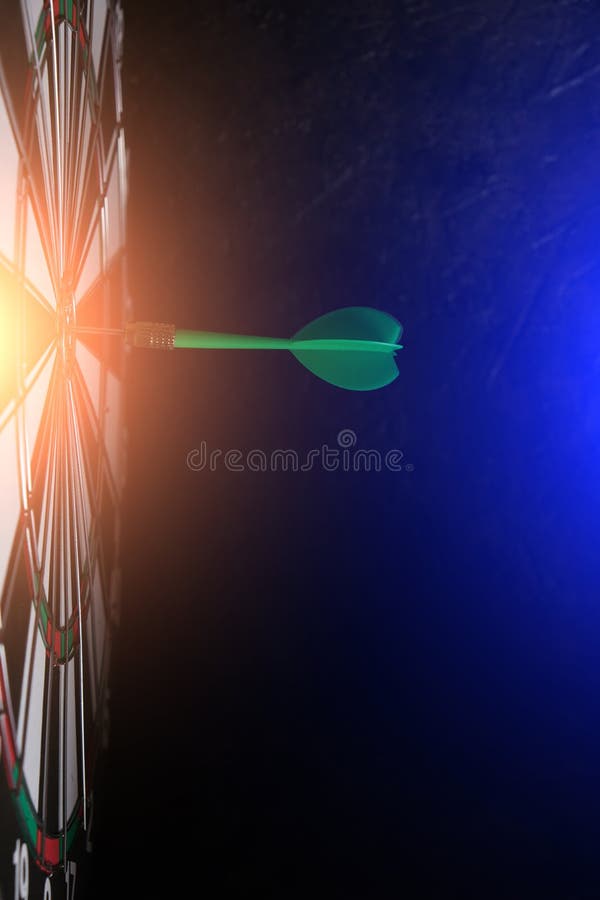 Dartboard with Green Dart Stuck in the Center with Bright Blue Light ...
