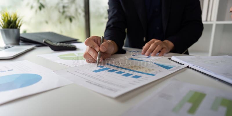 Data Analysis and Strategic Planning. a Professional Reviewing Graphs ...