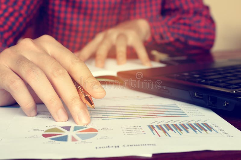 Data Analyzing with Businessman Holding Pen at Charts and Graph Stock ...