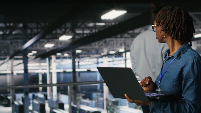 Data Center Computer Scientist Doing Maintenance Tasks on Laptop Stock ...