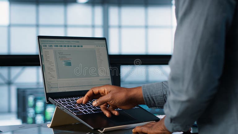 Data Center Engineer Coding On Notebook Adjusting Power Settings Stock