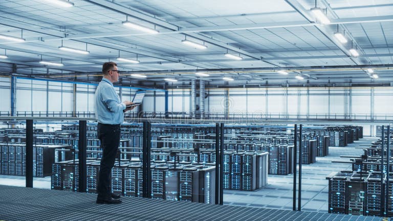 Data Center Engineer Using Laptop Computer. Server Farm Cloud Computing ...