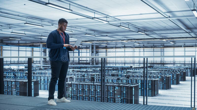 Data Center Engineer Using Laptop Computer. Server Farm Cloud Computing ...