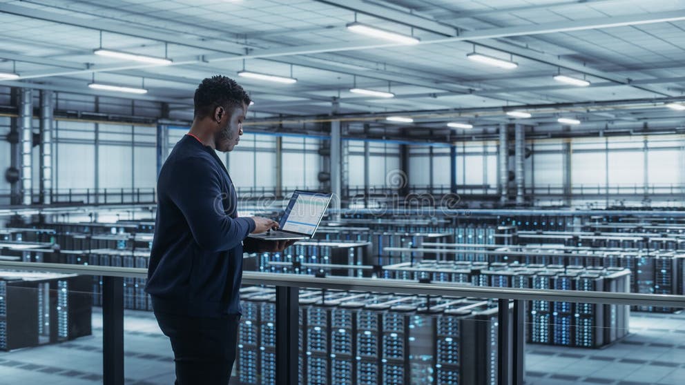 Data Center Engineer Using Laptop Computer. Server Farm Cloud Computing ...