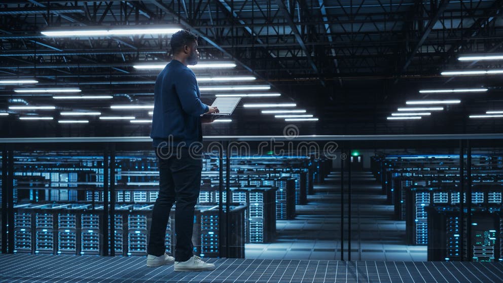 Data Center Engineer Using Laptop Computer. Server Farm Cloud Computing ...