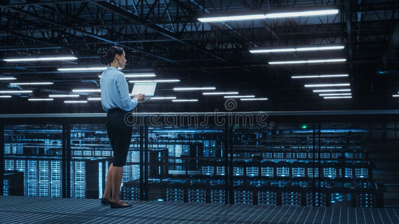 Data Center Engineer Using Laptop Computer. Server Farm Cloud Computing ...