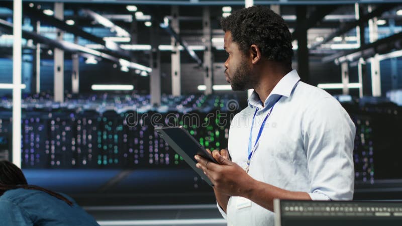 Data Center Engineer Using Tablet To Interpret AI Generated Data Analytics Graphs Stock Footage ...