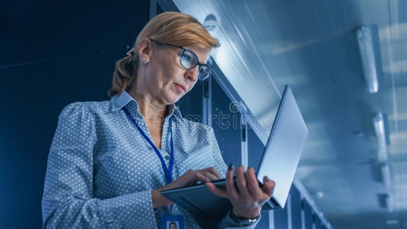 In Data Center: Low-Angle Portrait Shot of a Female it Technician ...