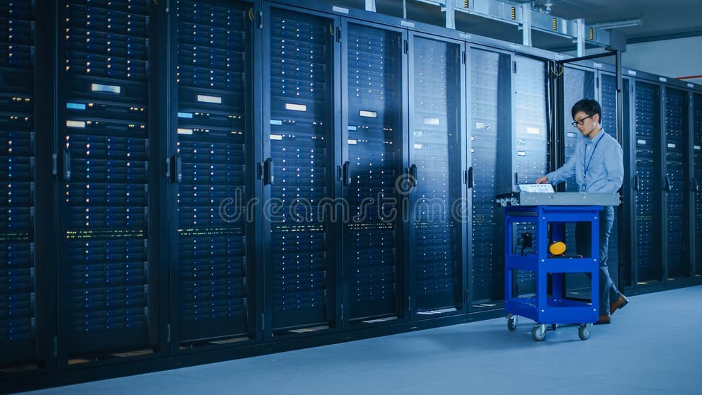 In Data Center: Male it Technician Running Maintenance Programme on a ...
