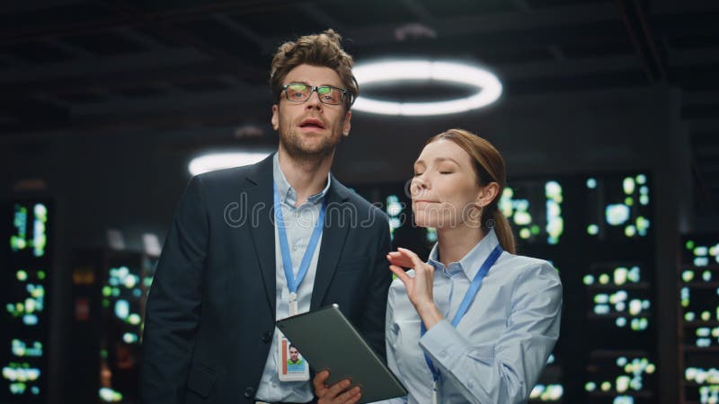 Data Center Woman Talking To it Man in Big Cloud Computing Server Farm ...