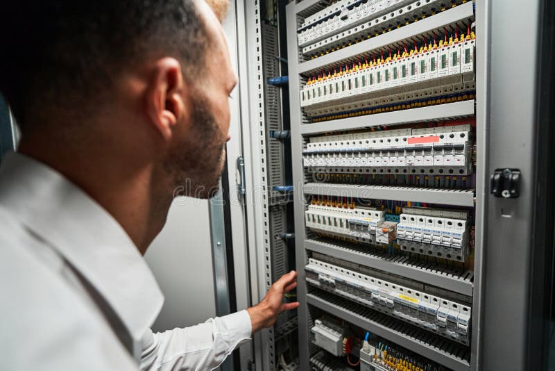 Data Center Worker Reaching for Electrical Switch Inside Cabinet Stock ...