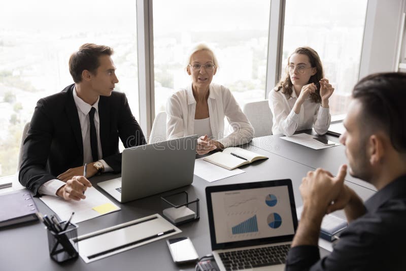 Two Business Executives Standing at Meeting Table with Document Stock ...