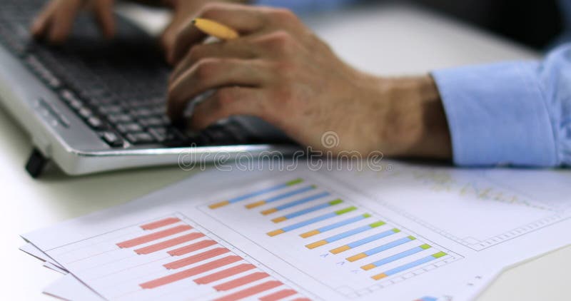 Data Entry - Clerk Working with Statistical Charts and Typing on ...
