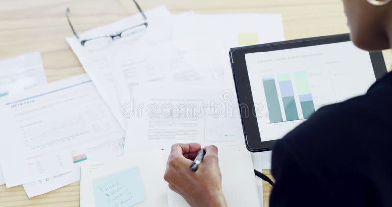 Data, Finance and Graph with an Accountant Writing on a Document in Her ...