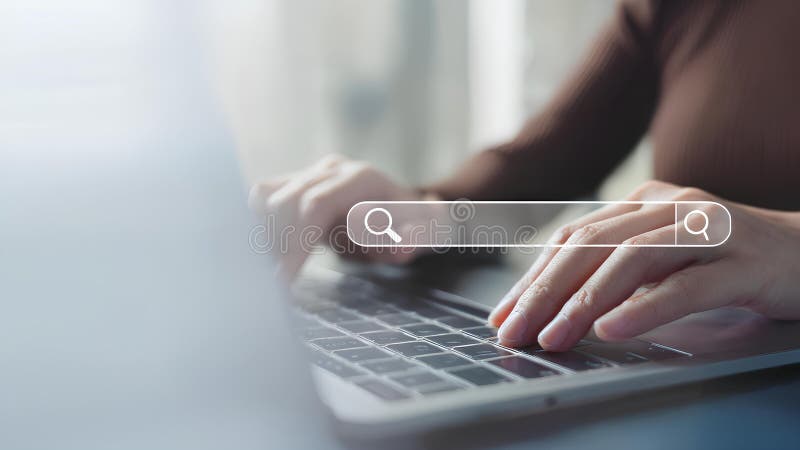 A Woman Typing on Her Laptop Keyboard, Actively Searching for ...