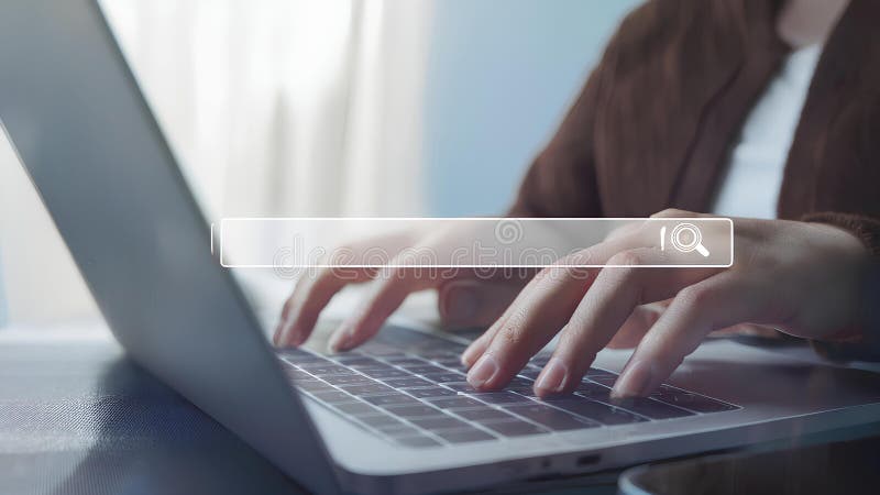 A Woman Typing on Her Laptop Keyboard, Actively Searching for ...