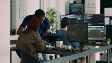 Database Developer Explaining Algorithm To Colleague Coder Pointing at ...