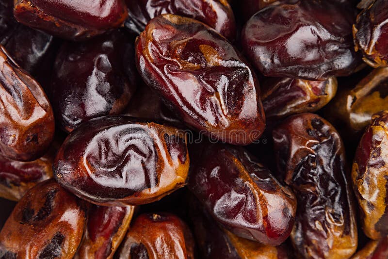 Date Fruit Closeup Background. Heap of Dried Shiny Brown Red Date Fruit ...
