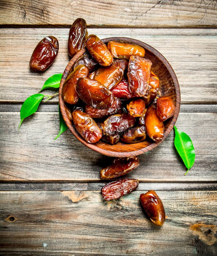 Dates with a Bowl with Green Leaves Stock Image - Image of dessert ...