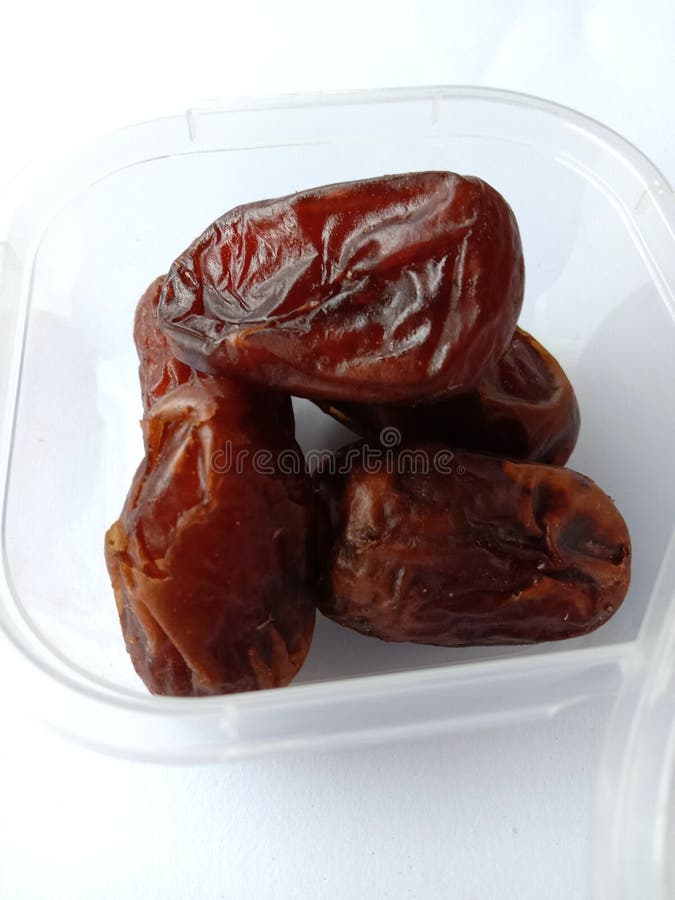 Dates in a plastic bowl stock image. Image of sweetness - 271608501