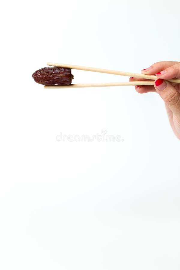 A Dates by a Woman Finger Using a Chop Sticks Stock Image - Image of ...